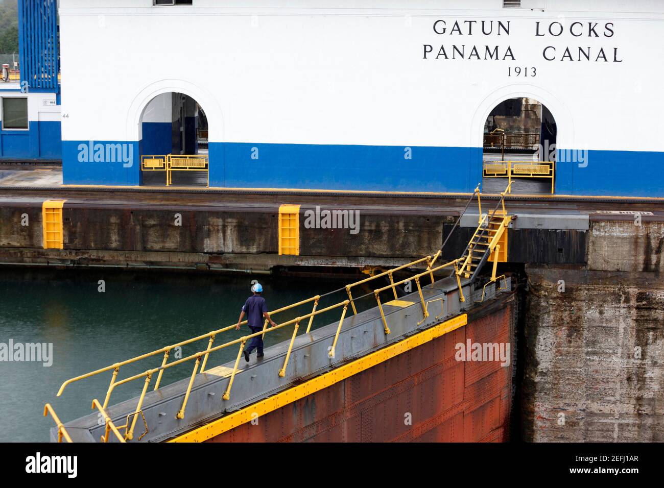 Man walking across close lock gate, Gatun locks, Panama Canal, Panama ...
