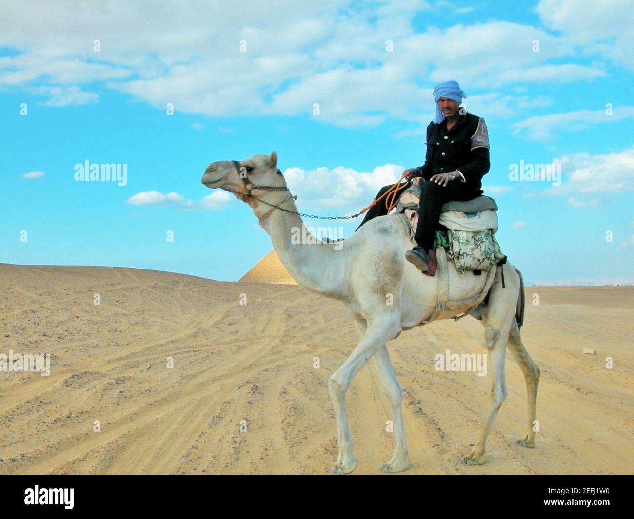 Portrait of a man riding a camel Stock Photo - Alamy