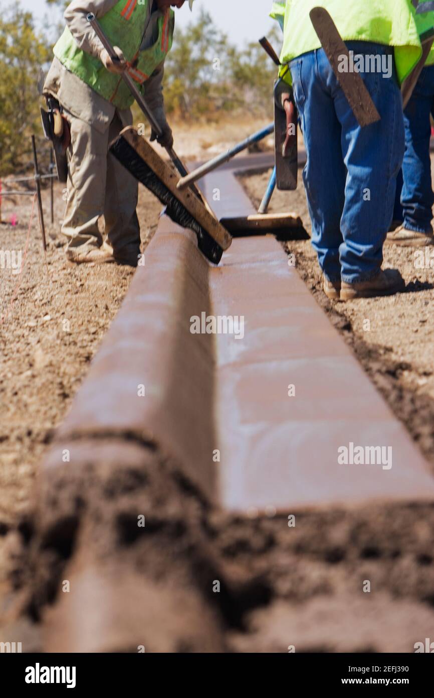 Three construction workers working at a construction site Stock Photo ...