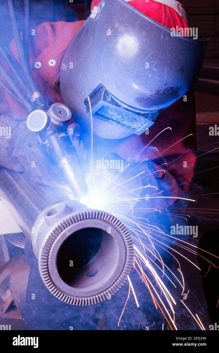Close-up of a welder welding a pipe Stock Photo - Alamy