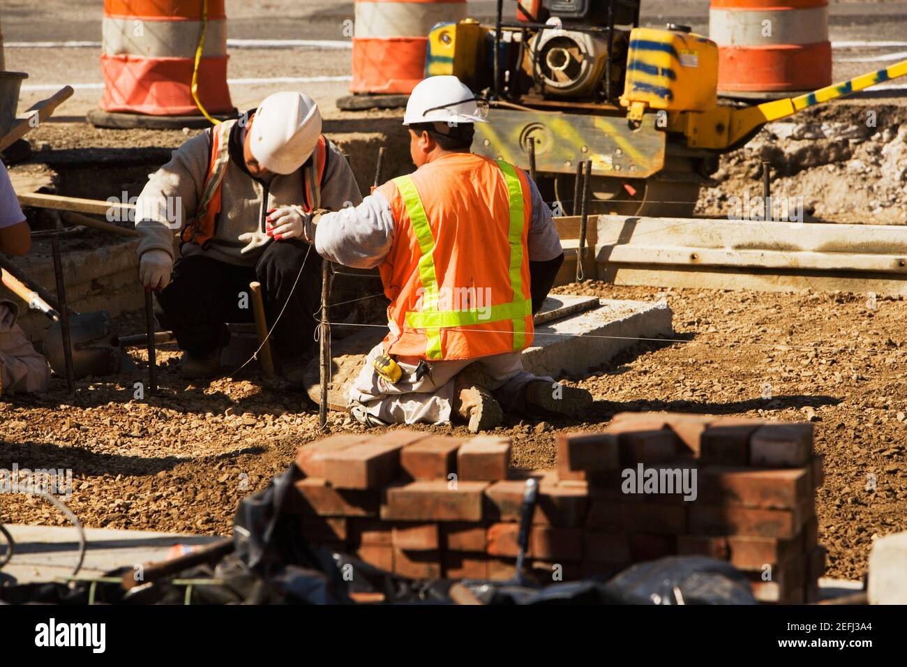 Two construction workers working at a construction site Stock Photo - Alamy