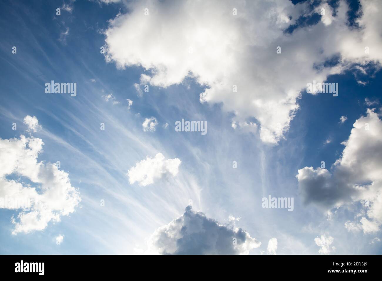 Surreal sun rays are striking through the clouds like an explosion ...