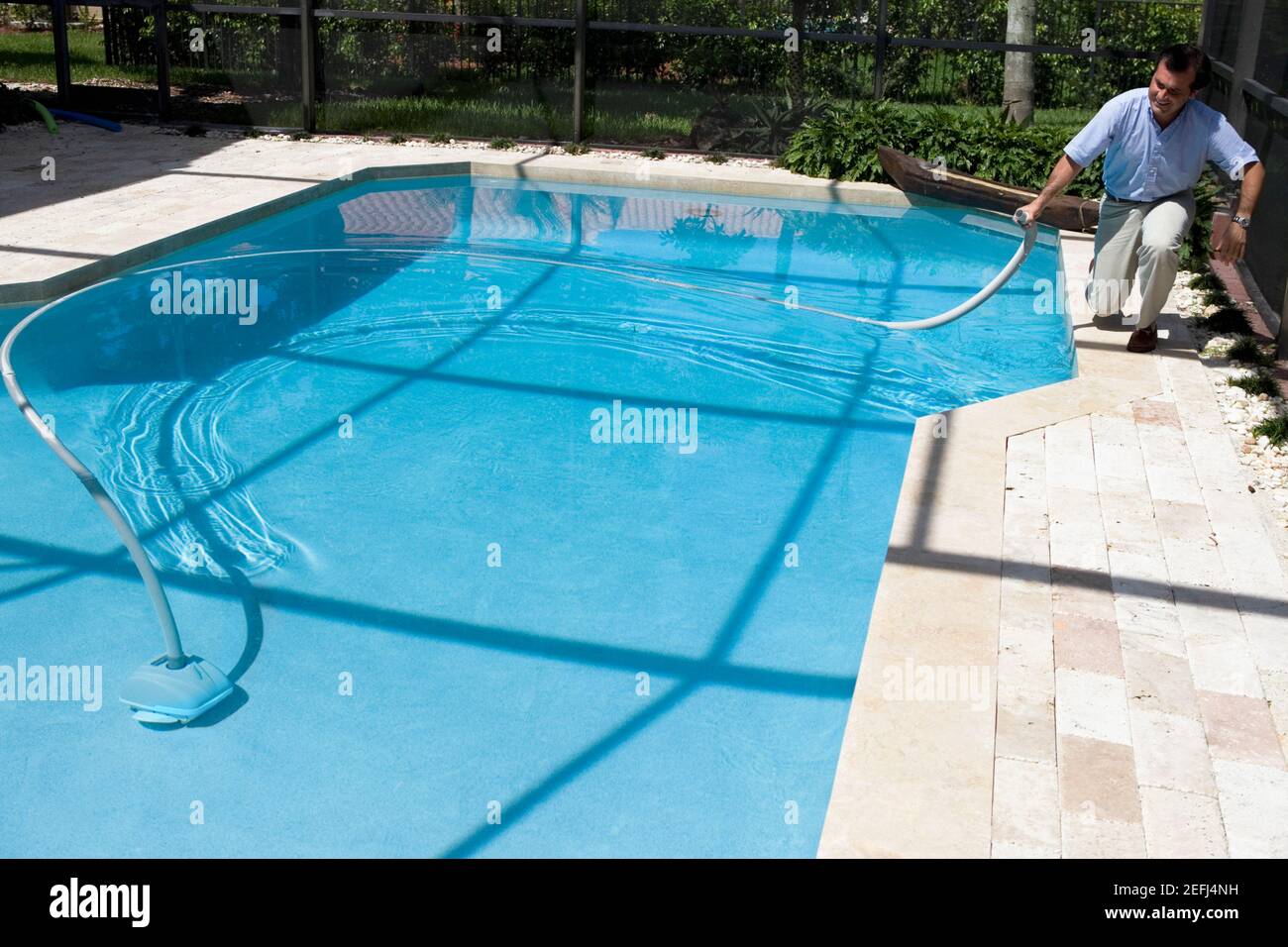 Black man cleaning pool hi-res stock photography and images - Alamy