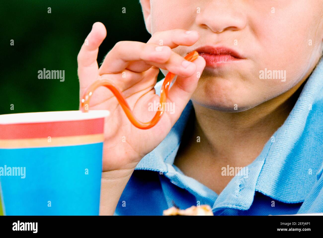 Close-up of a boy drinking with a straw Stock Photo - Alamy
