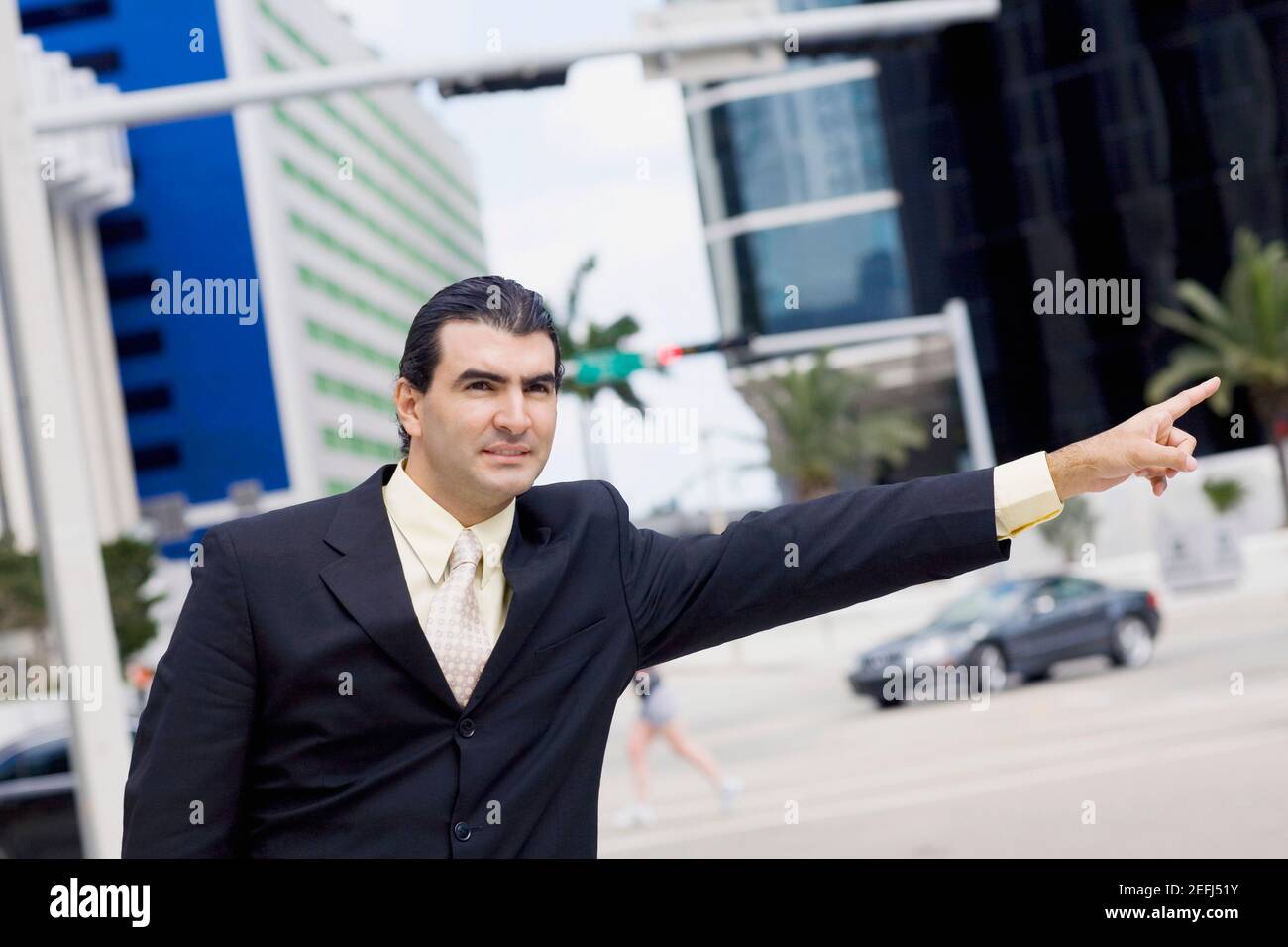 Businessman hailing a vehicle Stock Photo - Alamy