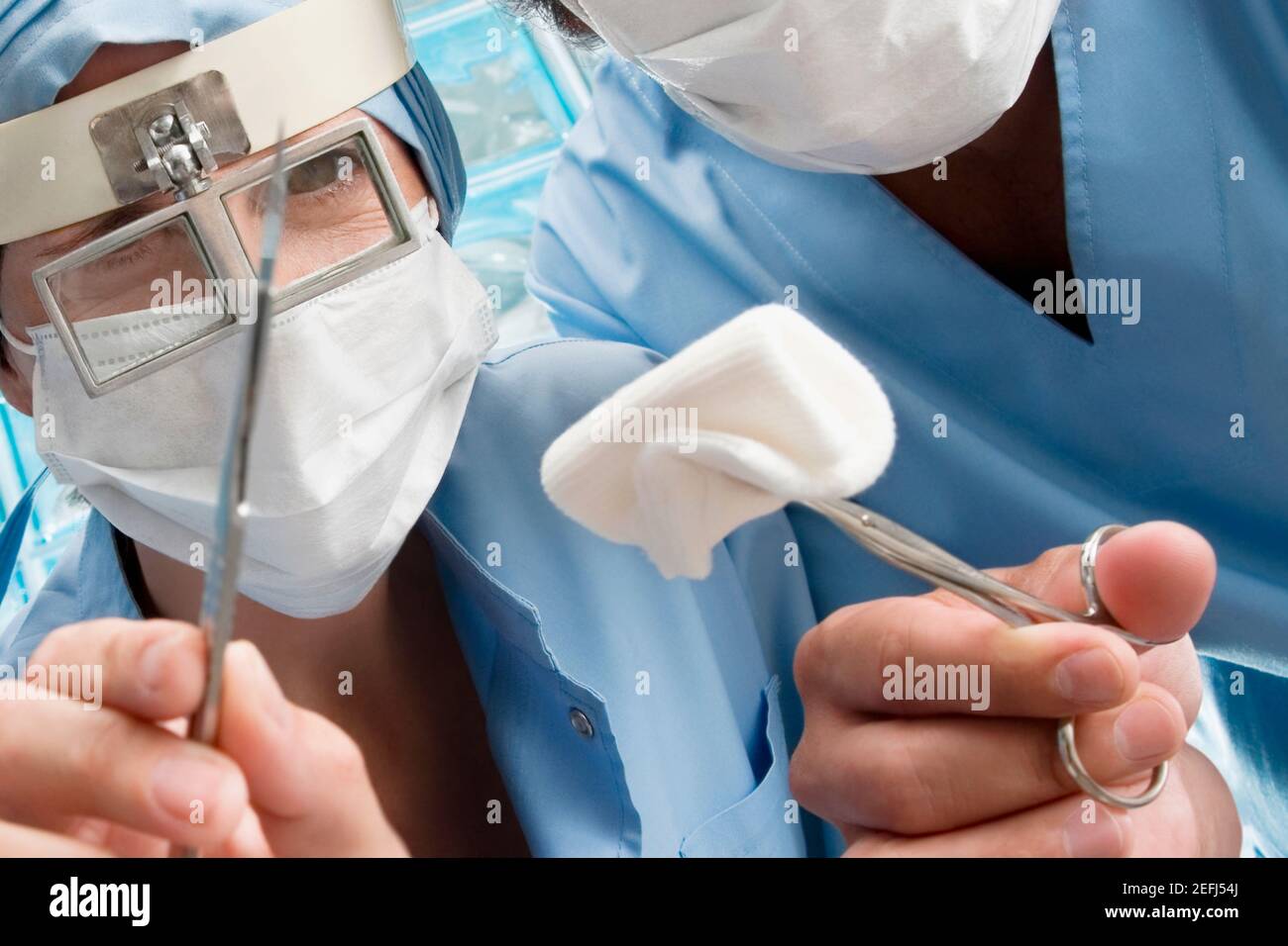 Two surgeons holding surgical scissors Stock Photo - Alamy