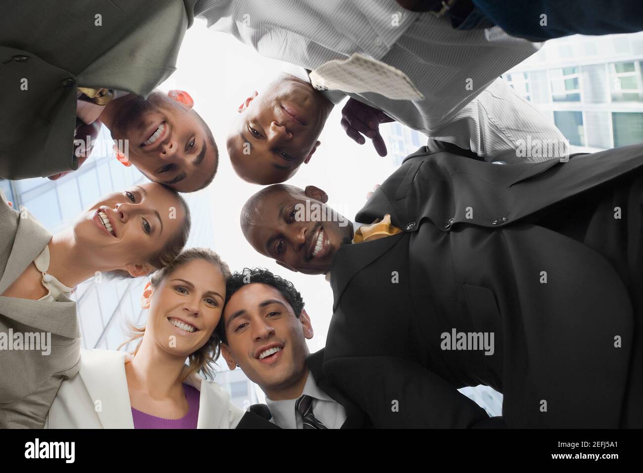 Low angle view of business executives standing in a huddle Stock Photo ...