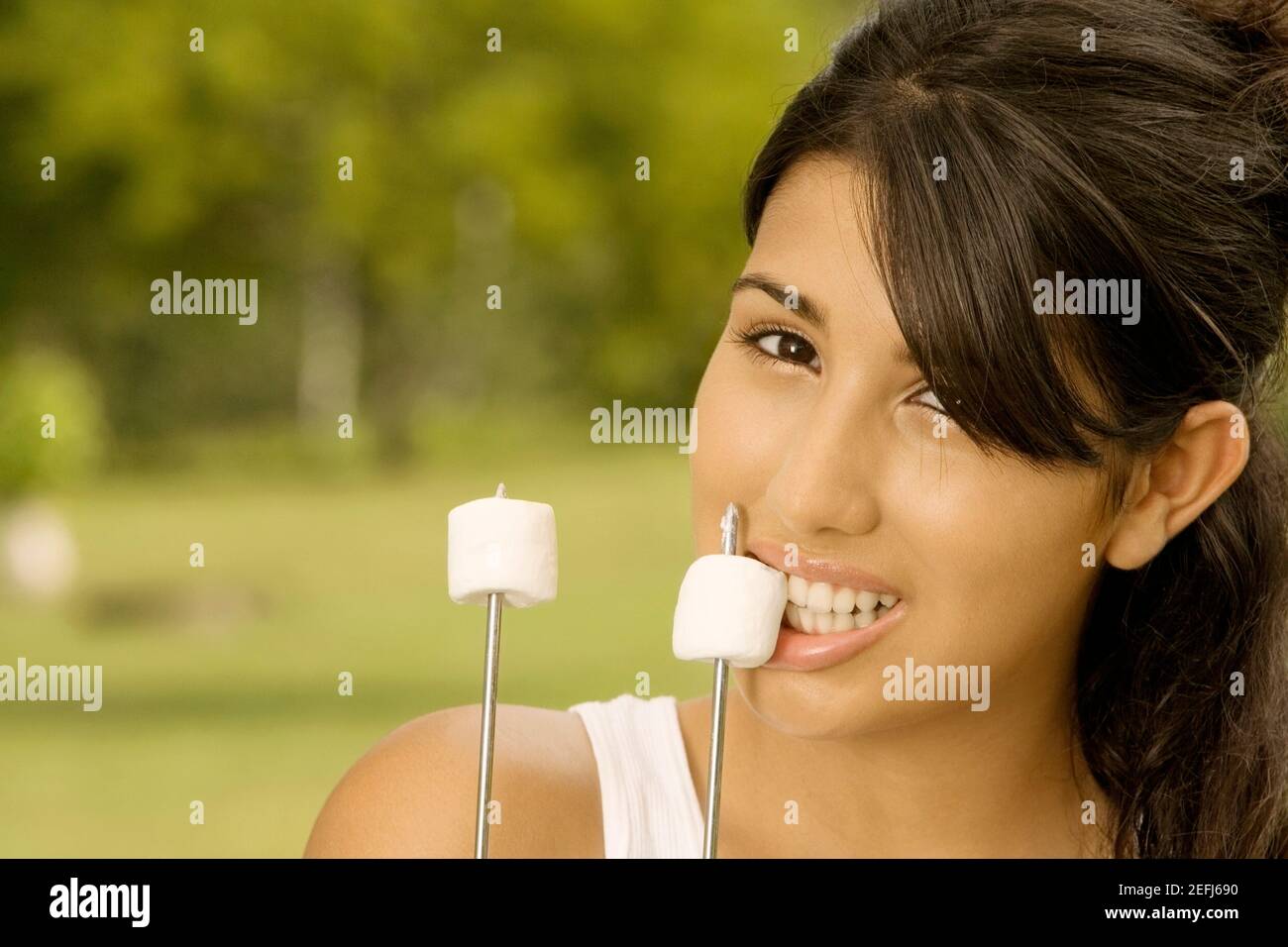 Portrait of a teenage girl eating marshmallow Stock Photo - Alamy