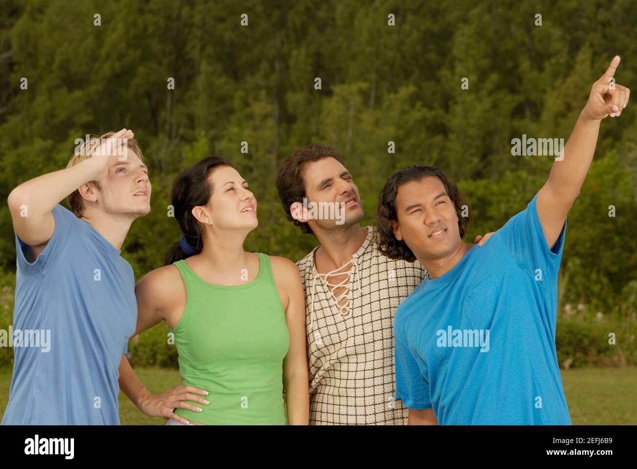 Young man pointing up to his friends Stock Photo - Alamy