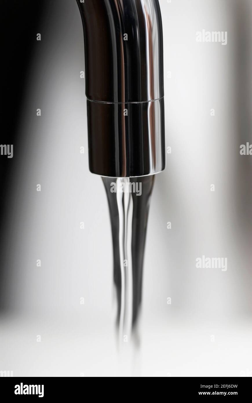 Water flowing out of a faucet Stock Photo - Alamy