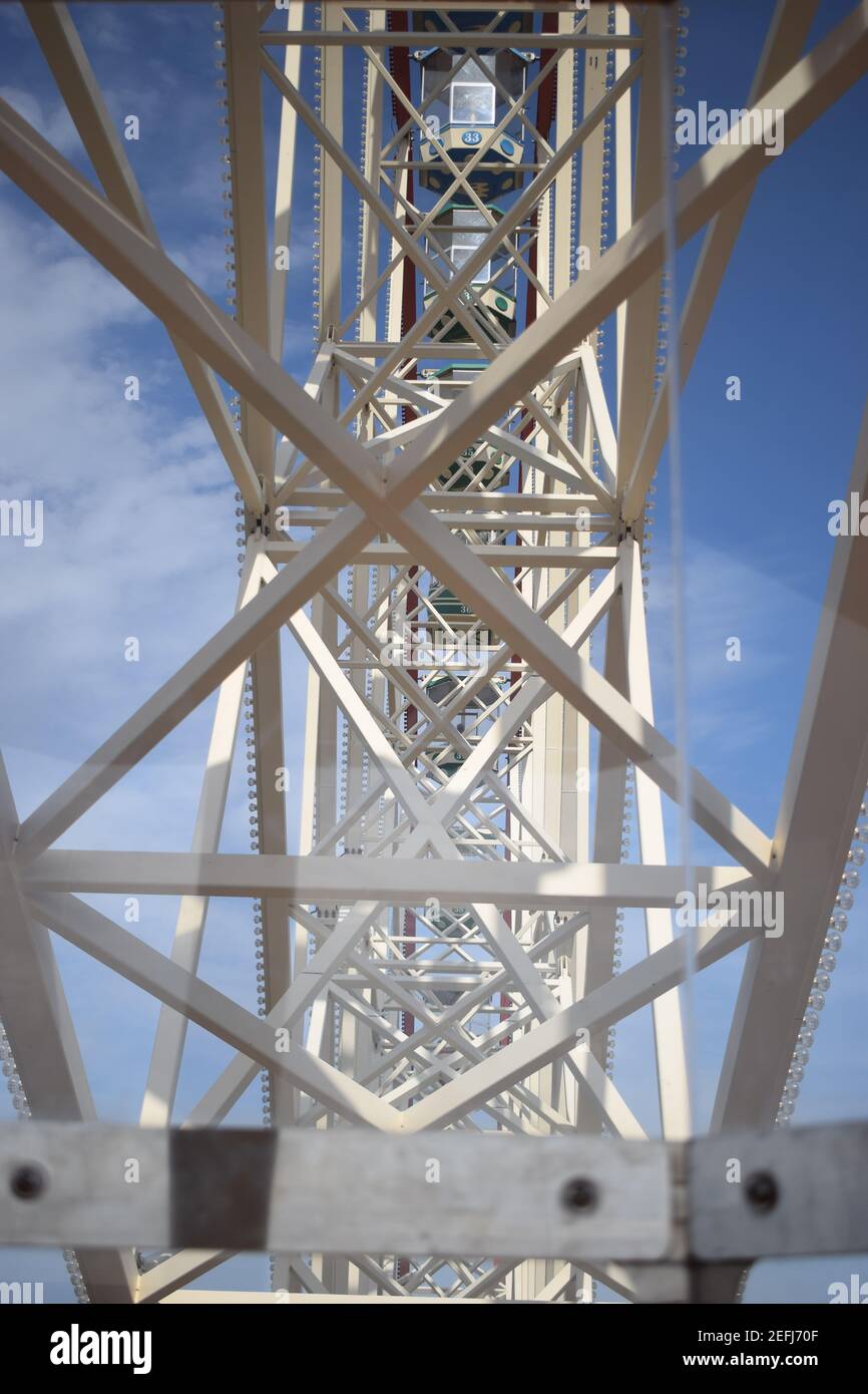 Ferris wheel construction seen from one of the cabins. Part of a white ...