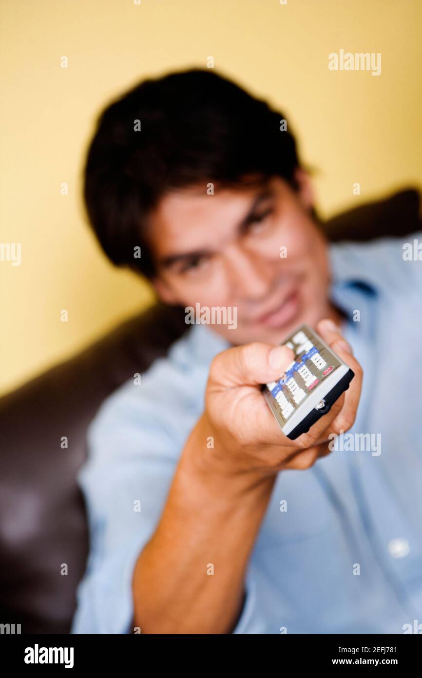 Mid adult man operating a remote control Stock Photo - Alamy