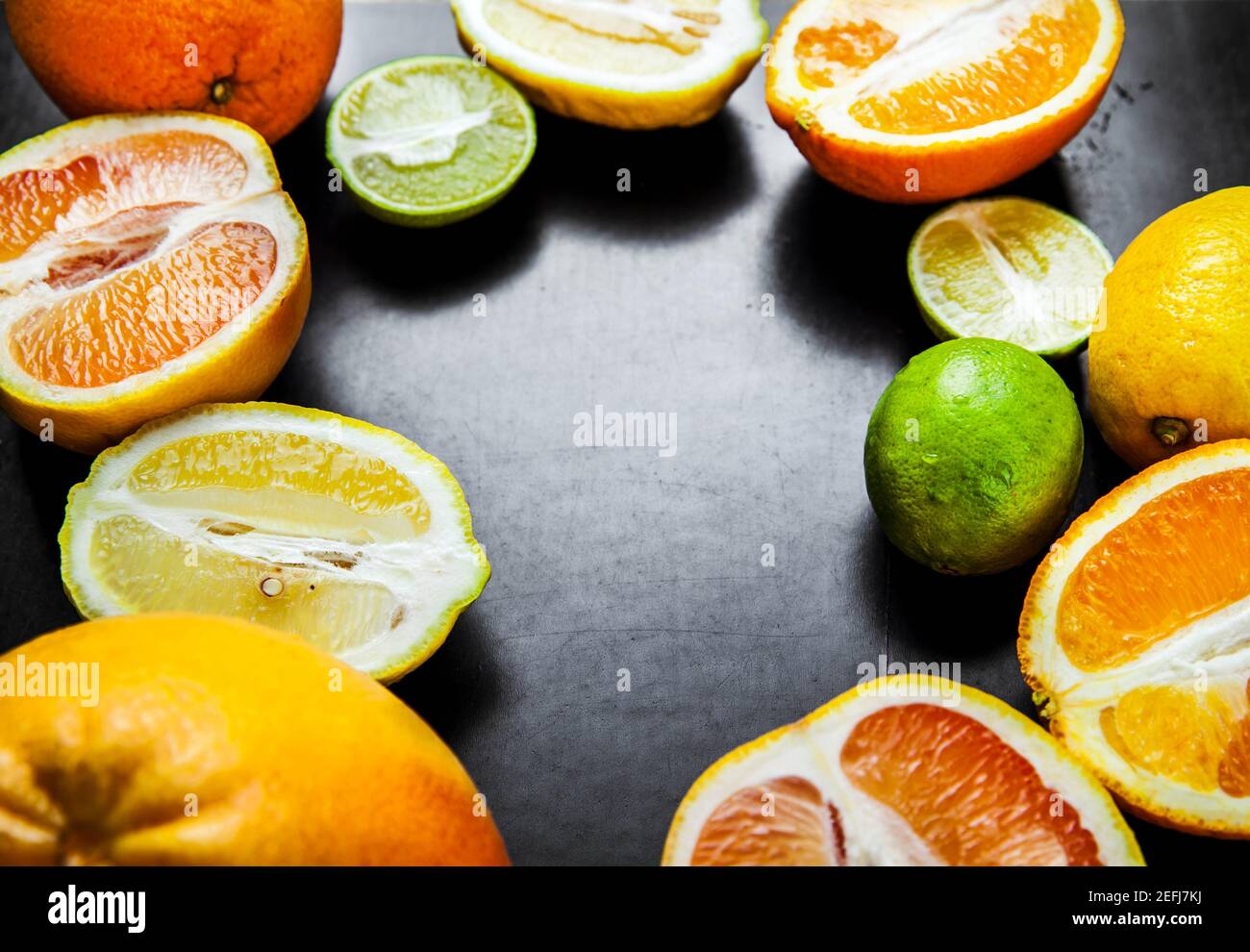 sliced citrus fruit on a black background. food and Stock Photo - Alamy