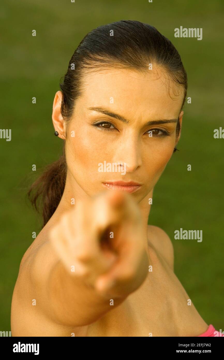 Portrait of a mid adult woman pointing forward Stock Photo - Alamy