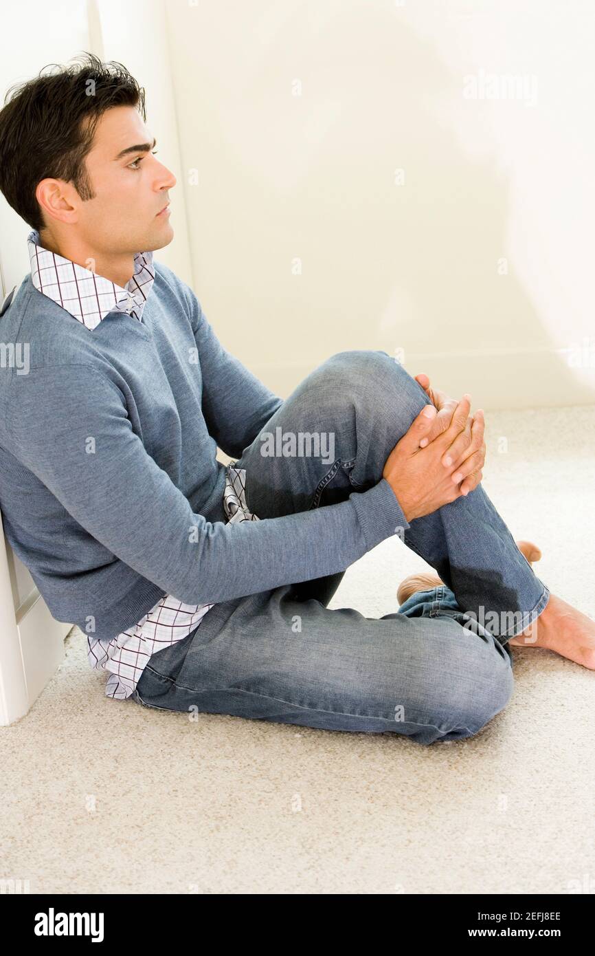 Side profile of a mid adult man sitting on the floor Stock Photo - Alamy