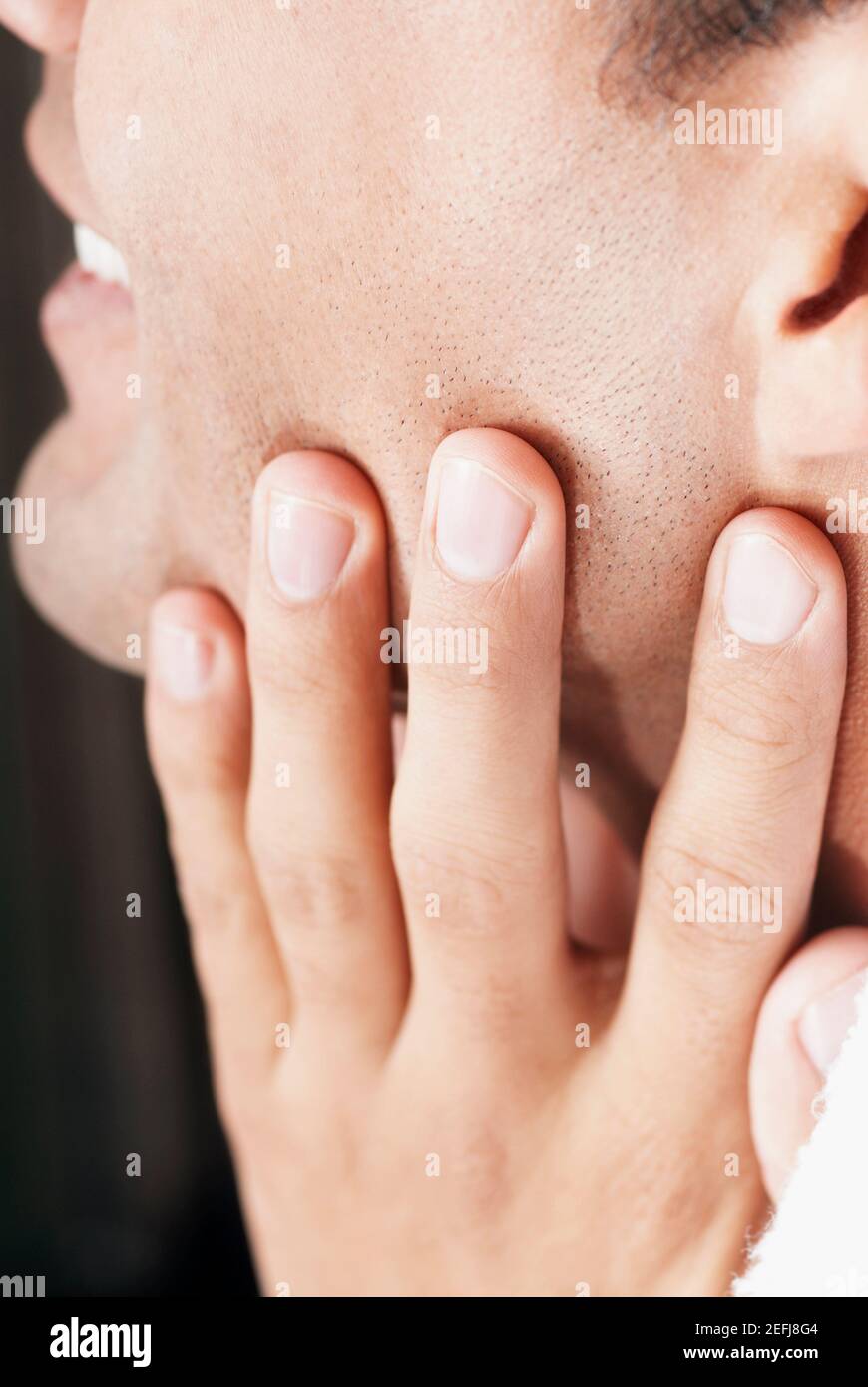 Man touching face side view hi-res stock photography and images - Alamy