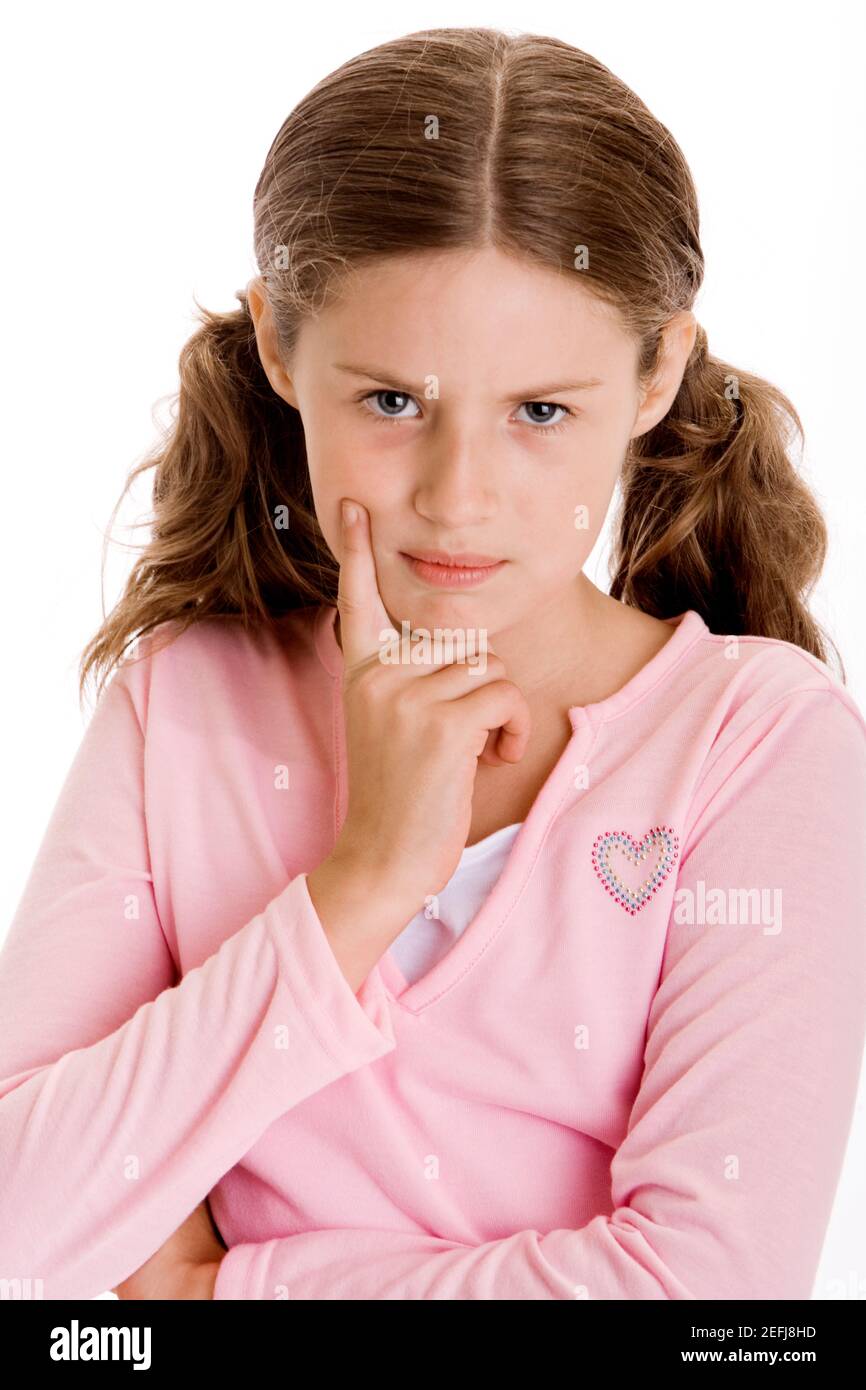 Girl thinking finger on cheek hi-res stock photography and images - Alamy