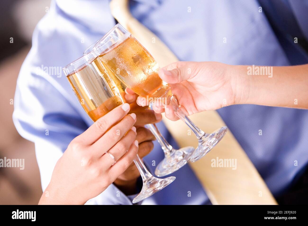 Three people toasting with champagne flutes Stock Photo - Alamy