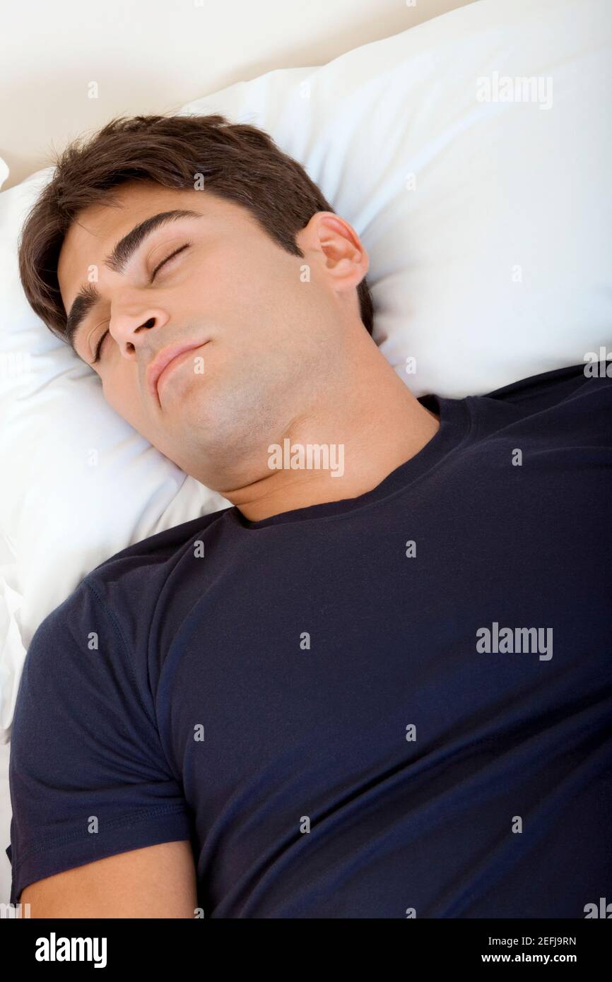 High angle view of a young man sleeping on a bed Stock Photo - Alamy