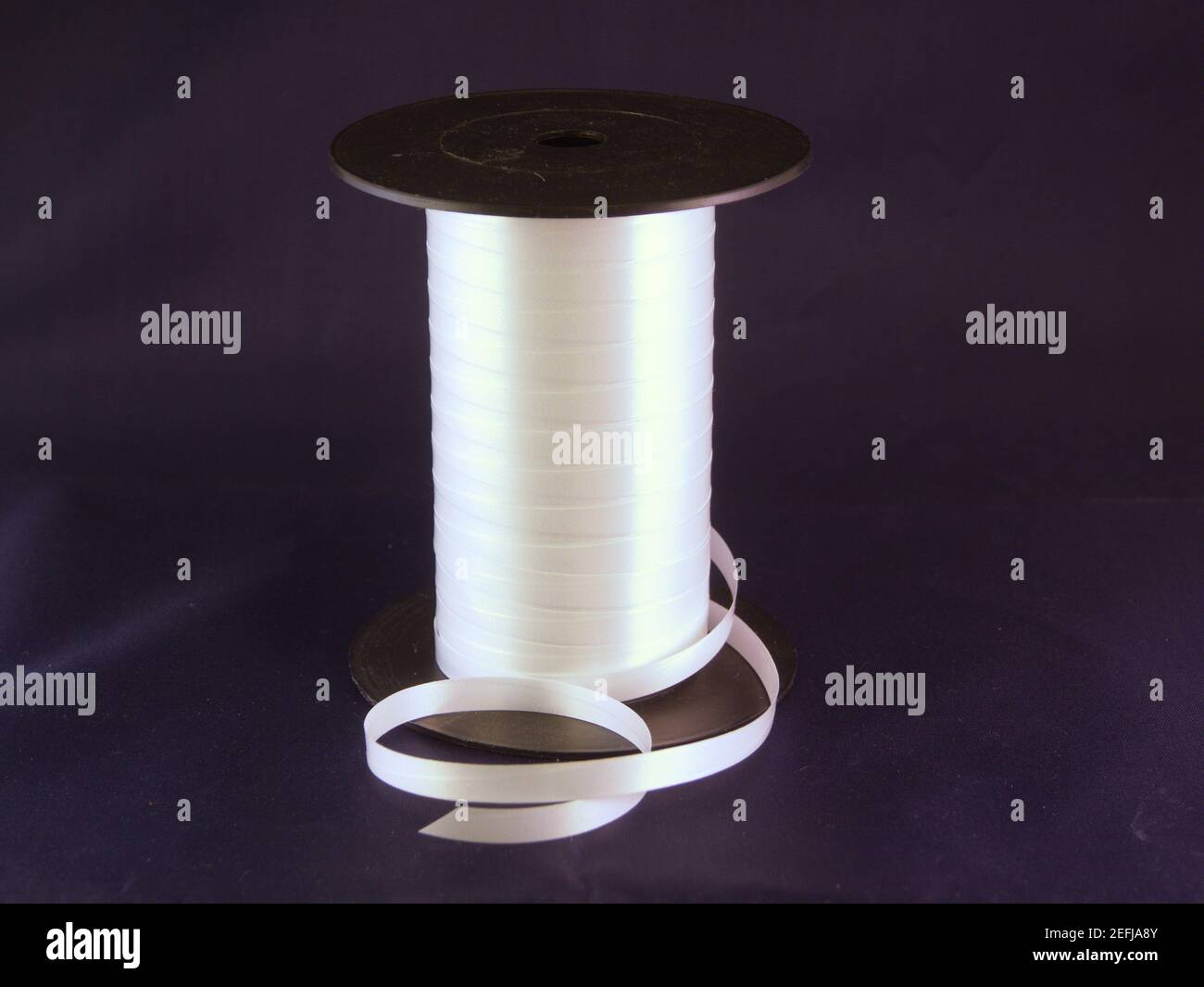 Glossy gift strings on plastic reels Stock Photo - Alamy