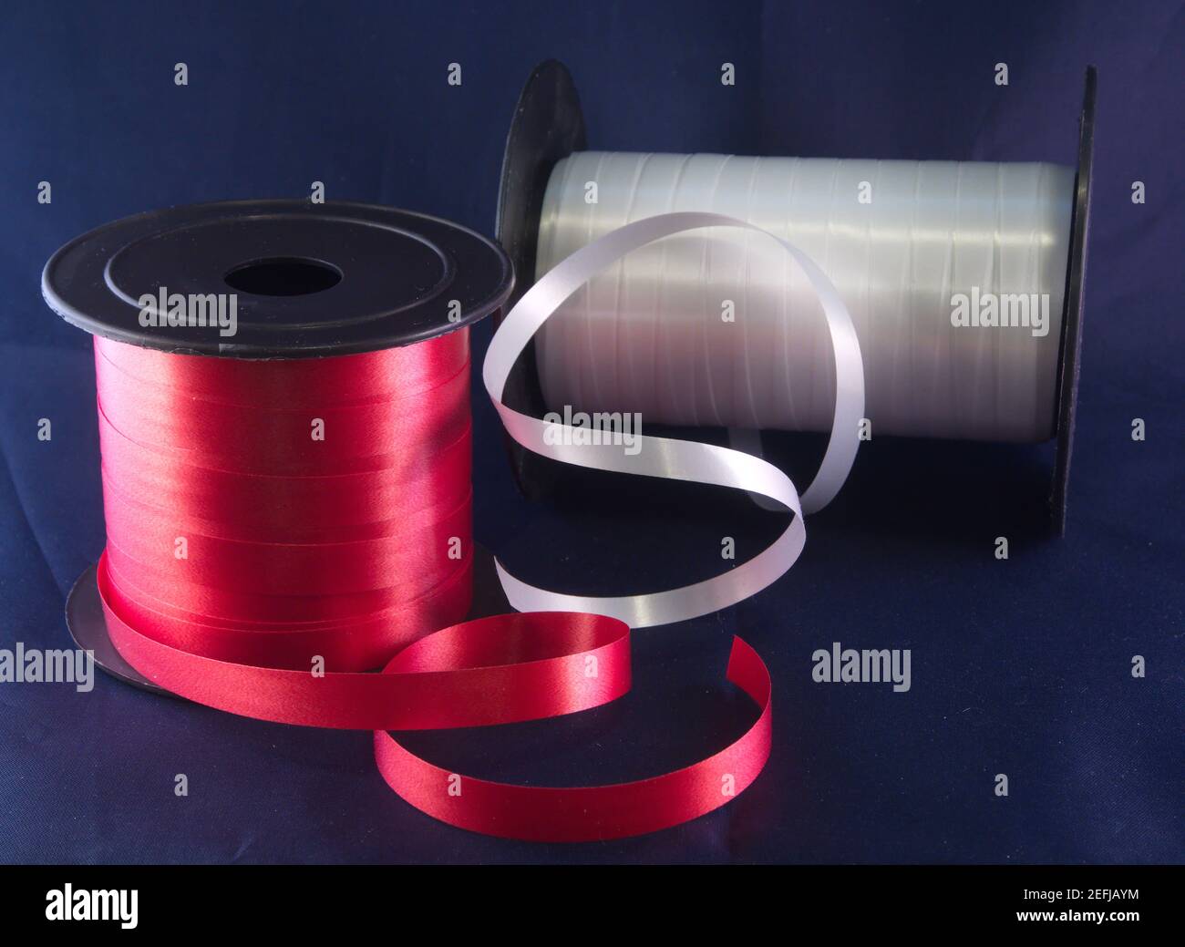 Glossy gift strings on plastic reels Stock Photo - Alamy