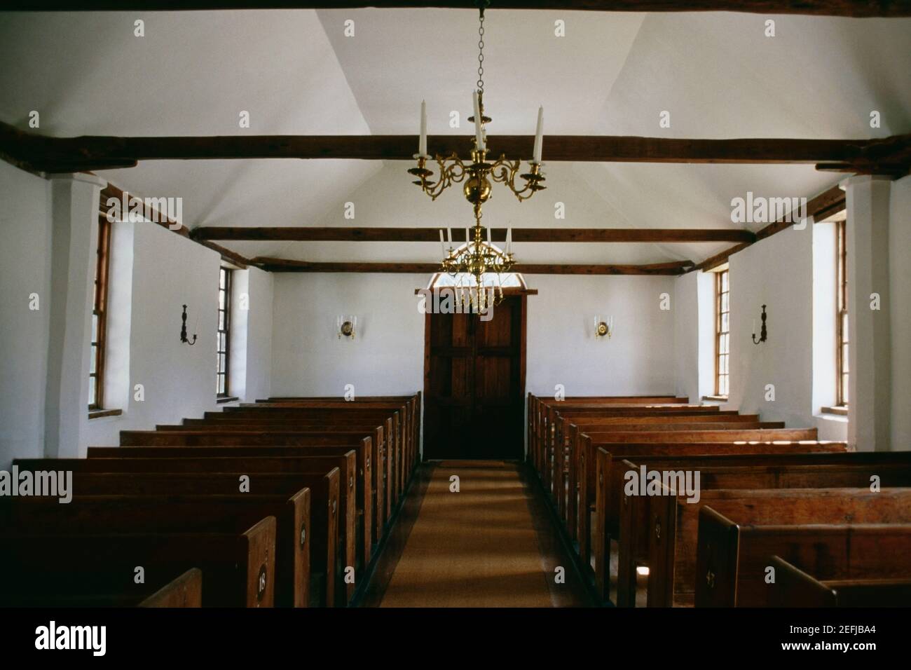 Front view of an elegant chandelier above the aisle, Old devonshire ...
