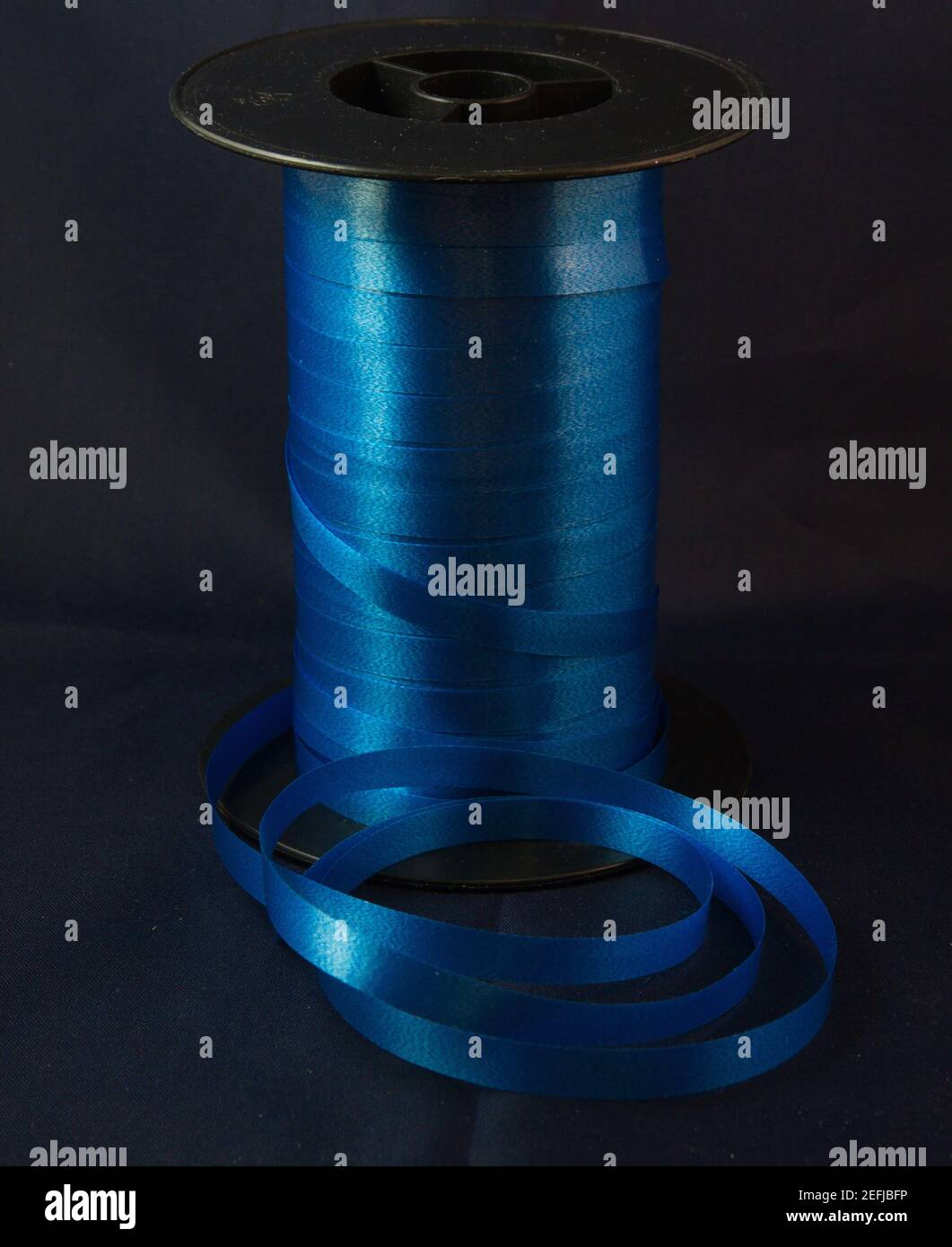 Glossy gift strings on plastic reels Stock Photo - Alamy
