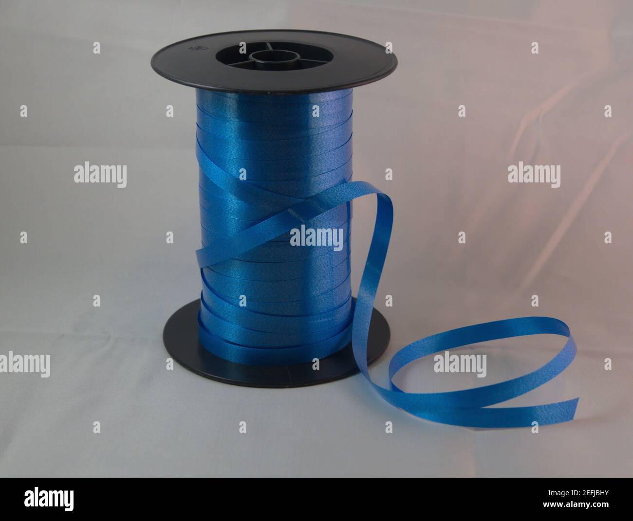 Glossy gift strings on plastic reels Stock Photo - Alamy