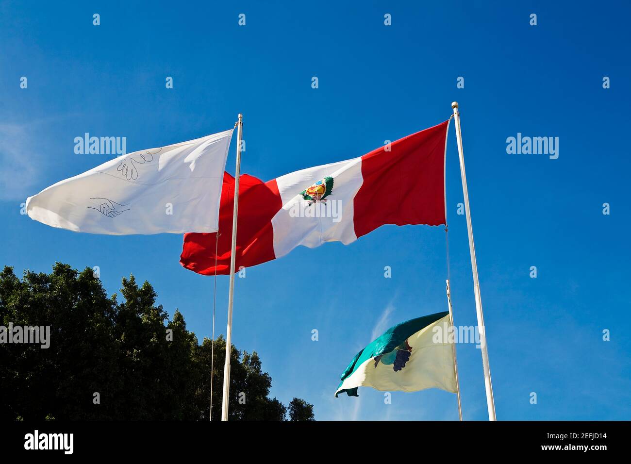 Low angle view of flags fluttering, Plaza-De-Armas, Pisco, Ica Region ...