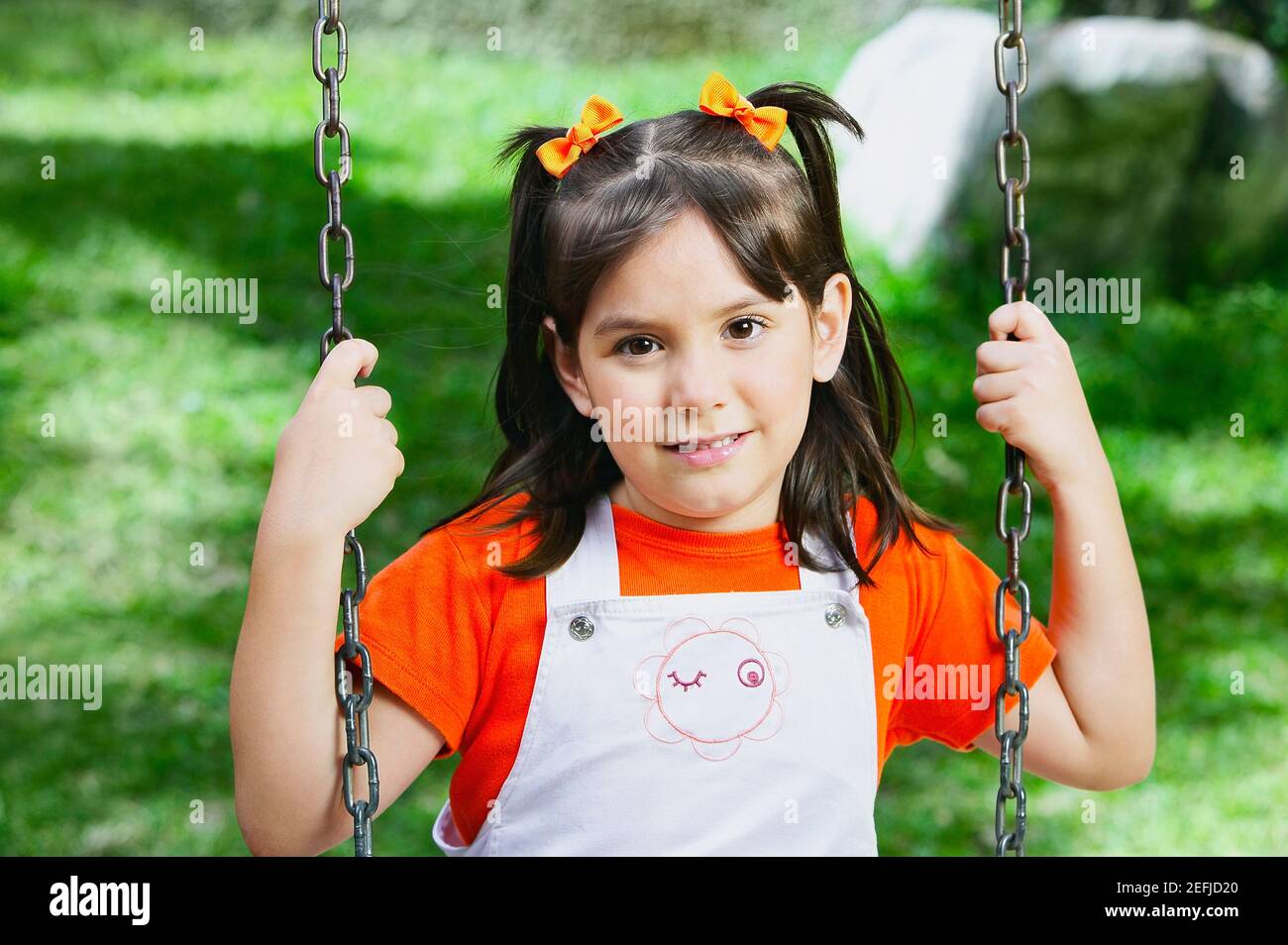 Portrait of a girl on a chain swing ride Stock Photo - Alamy