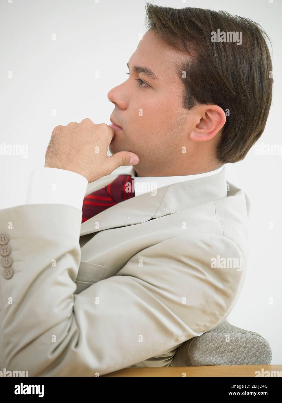 Side profile of a businessman thinking with his hand on his chin Stock ...