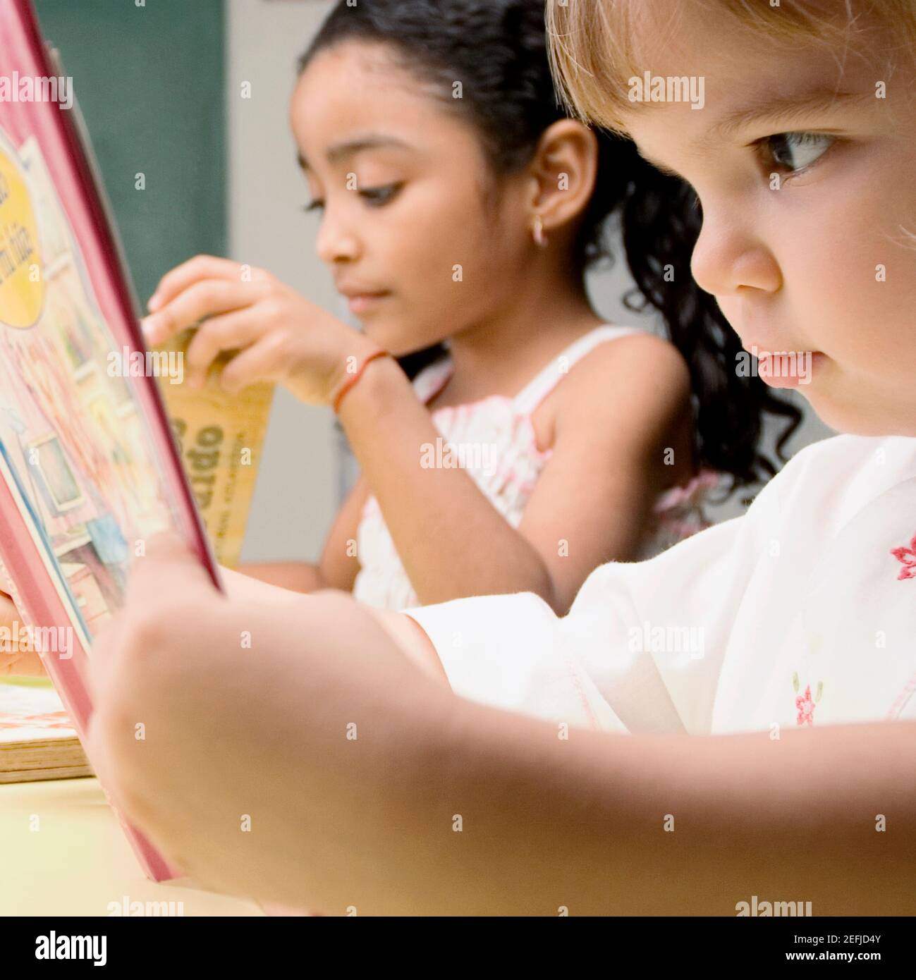 Two students reading in a classroom Stock Photo - Alamy
