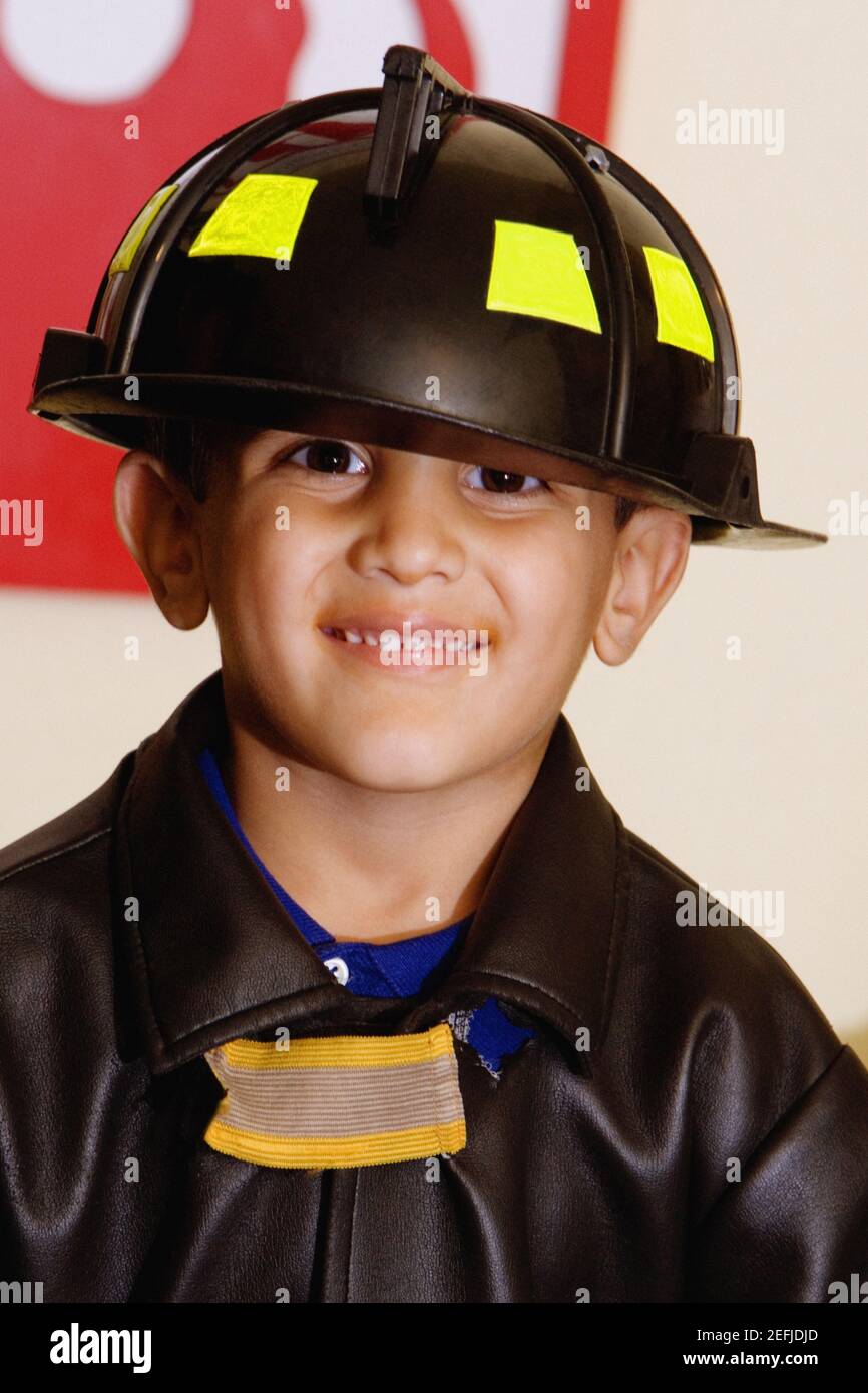 Portrait of a boy wearing a fireman costume Stock Photo - Alamy