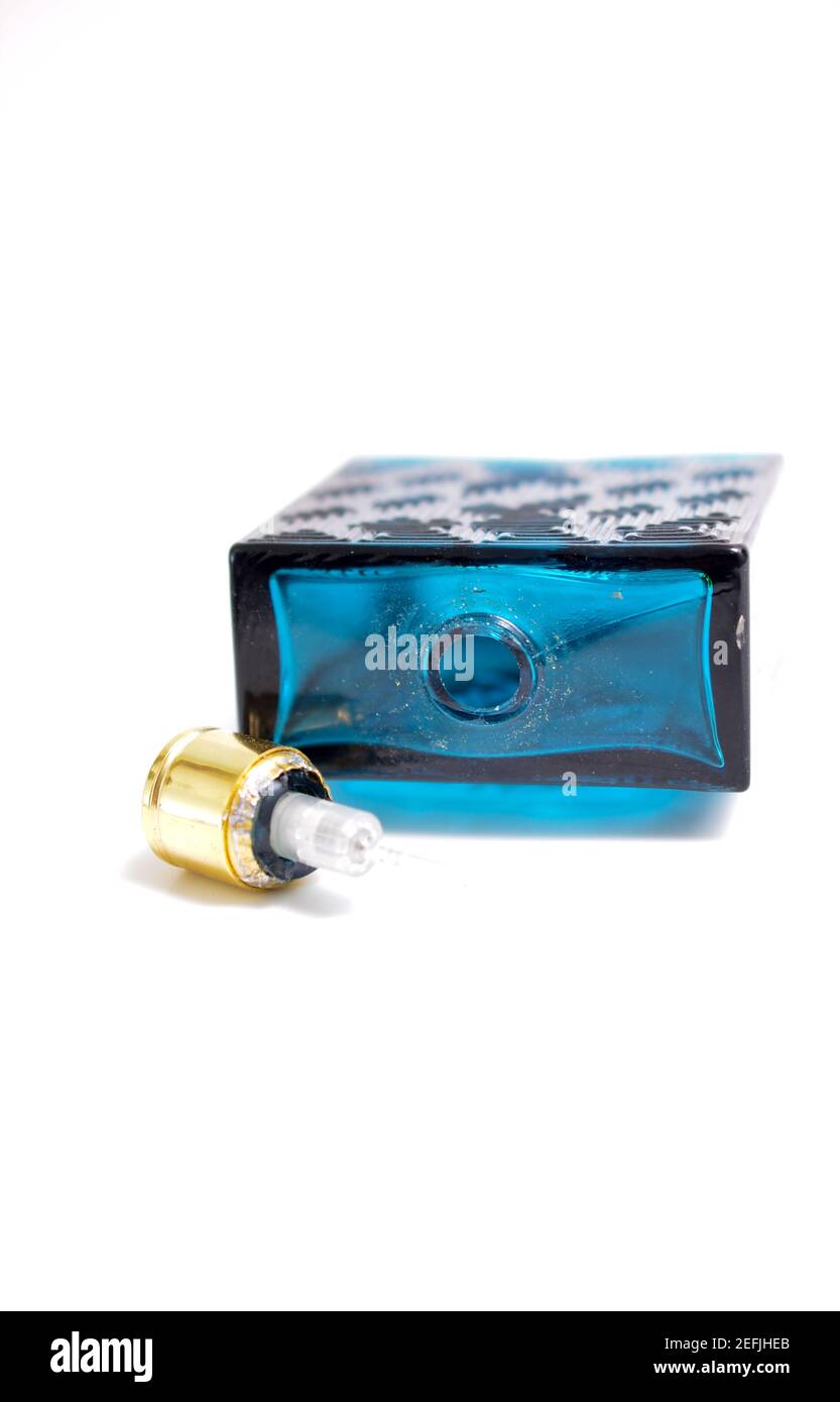 Broken perfume bottle on white background Stock Photo - Alamy