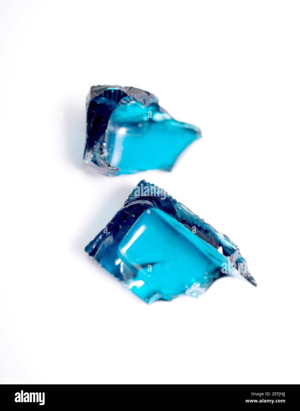 pieces of a crushed blue bottle on white background Stock Photo - Alamy