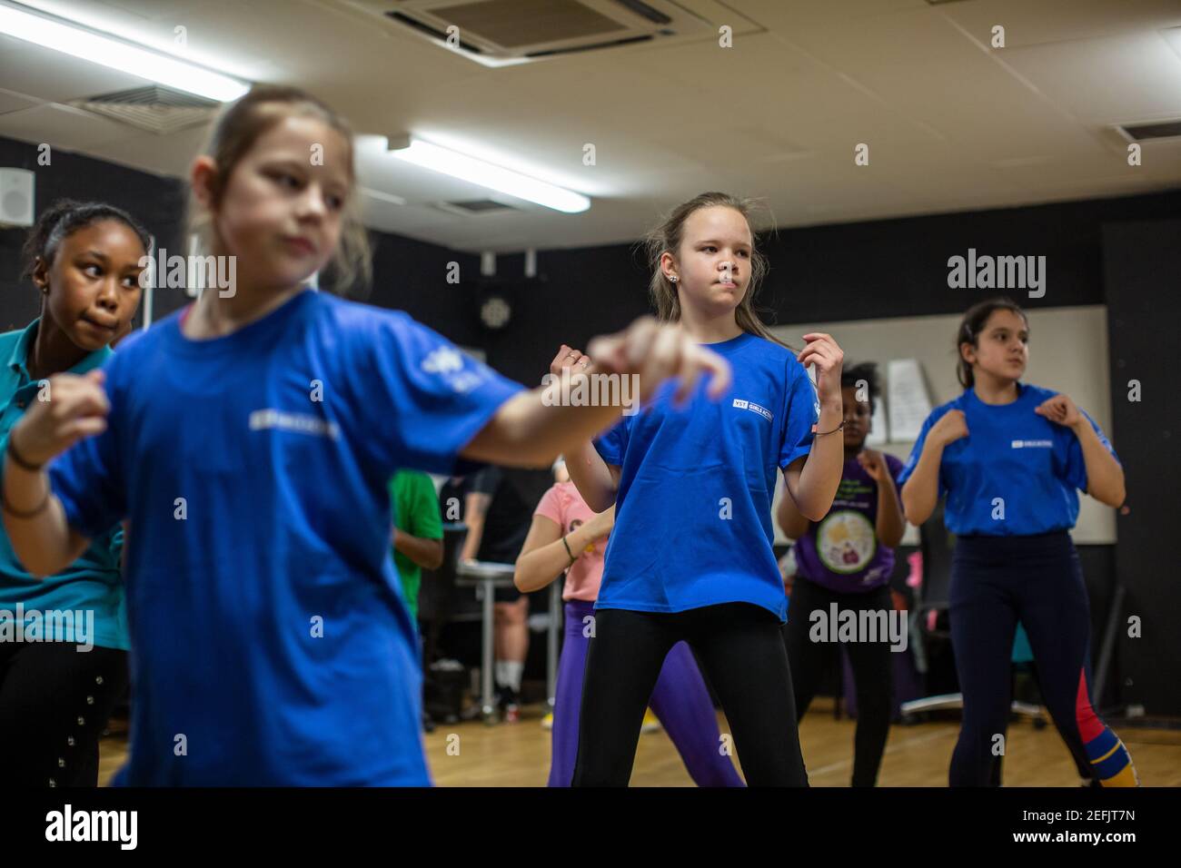 Schoolchildren participate in an indoor Physical Education (PE) lesson ...