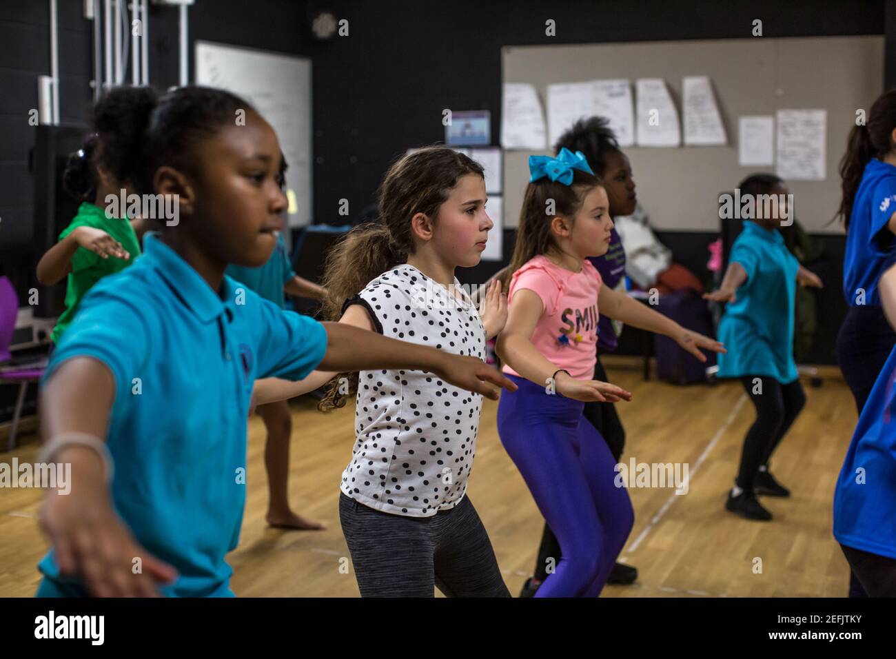 Schoolchildren participate in an indoor Physical Education (PE) lesson ...