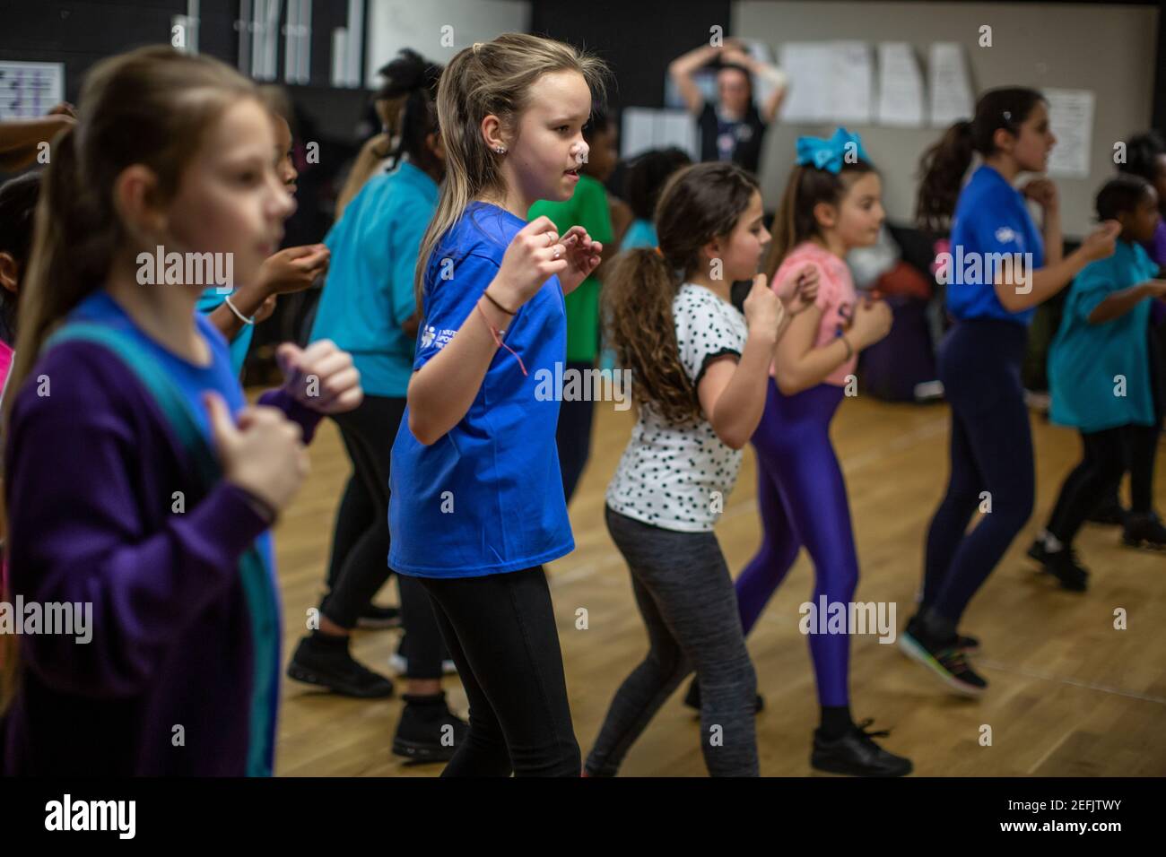 Schoolchildren participate in an indoor Physical Education (PE) lesson ...