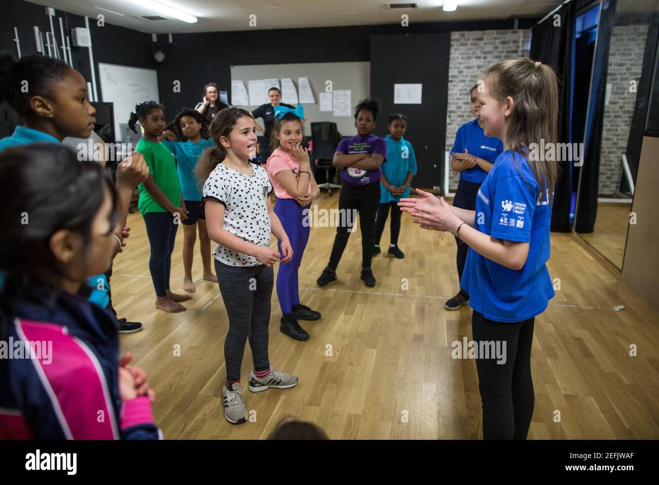 Schoolchildren participate in an indoor Physical Education (PE) lesson ...
