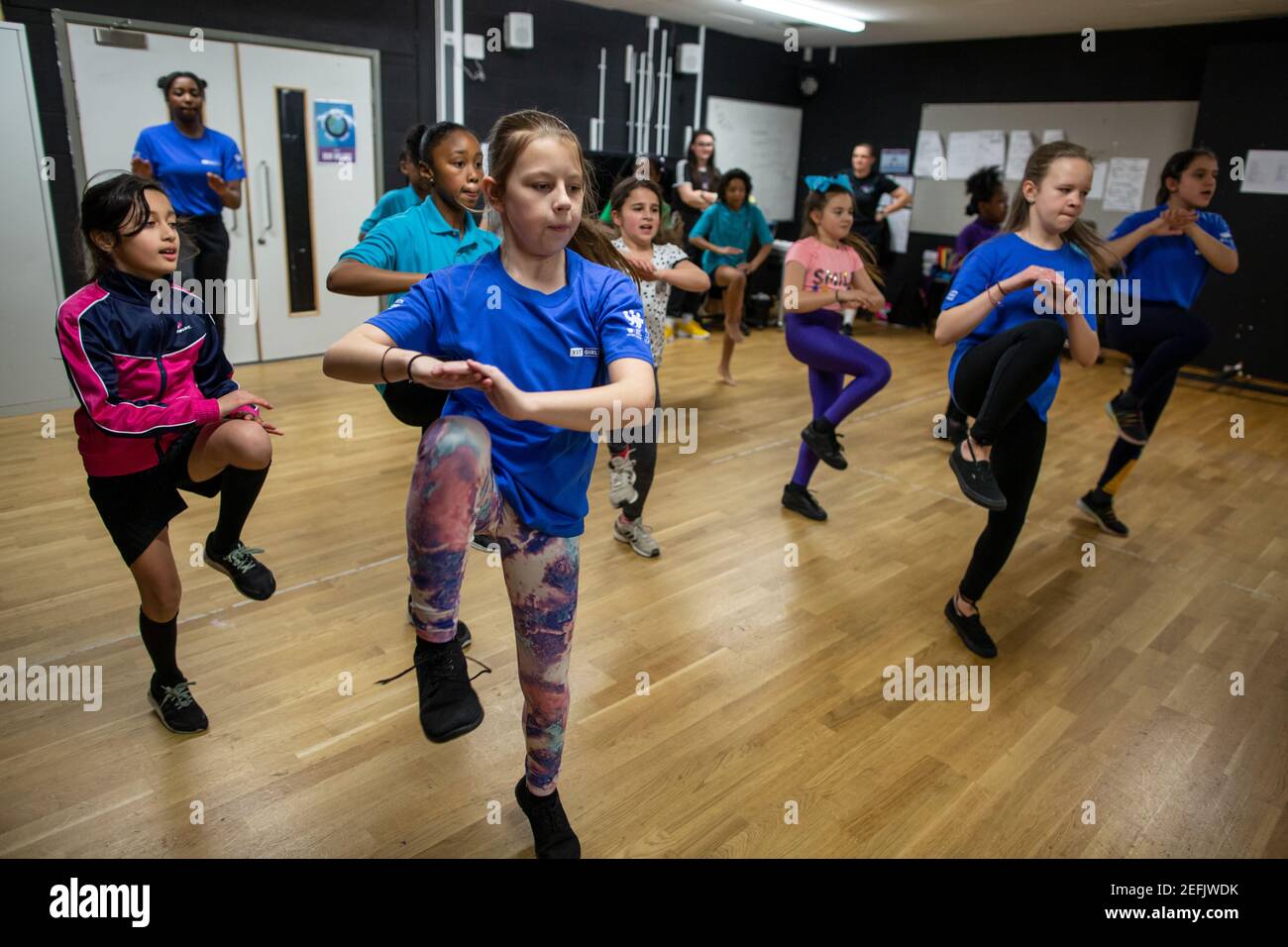 Schoolchildren participate in an indoor Physical Education (PE) lesson ...