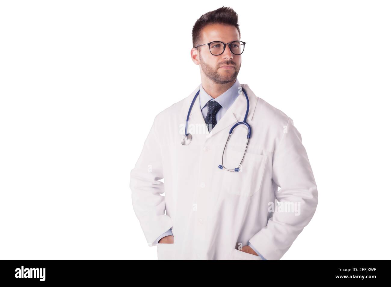 Studio portrait of male doctor standing at isolated white background ...