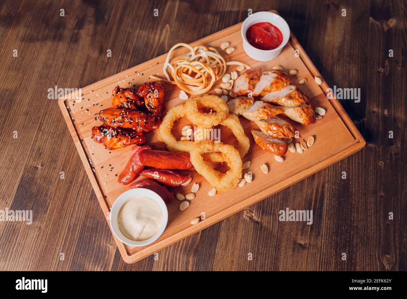 wide selection of snacks for beer with different sauces on parchment ...