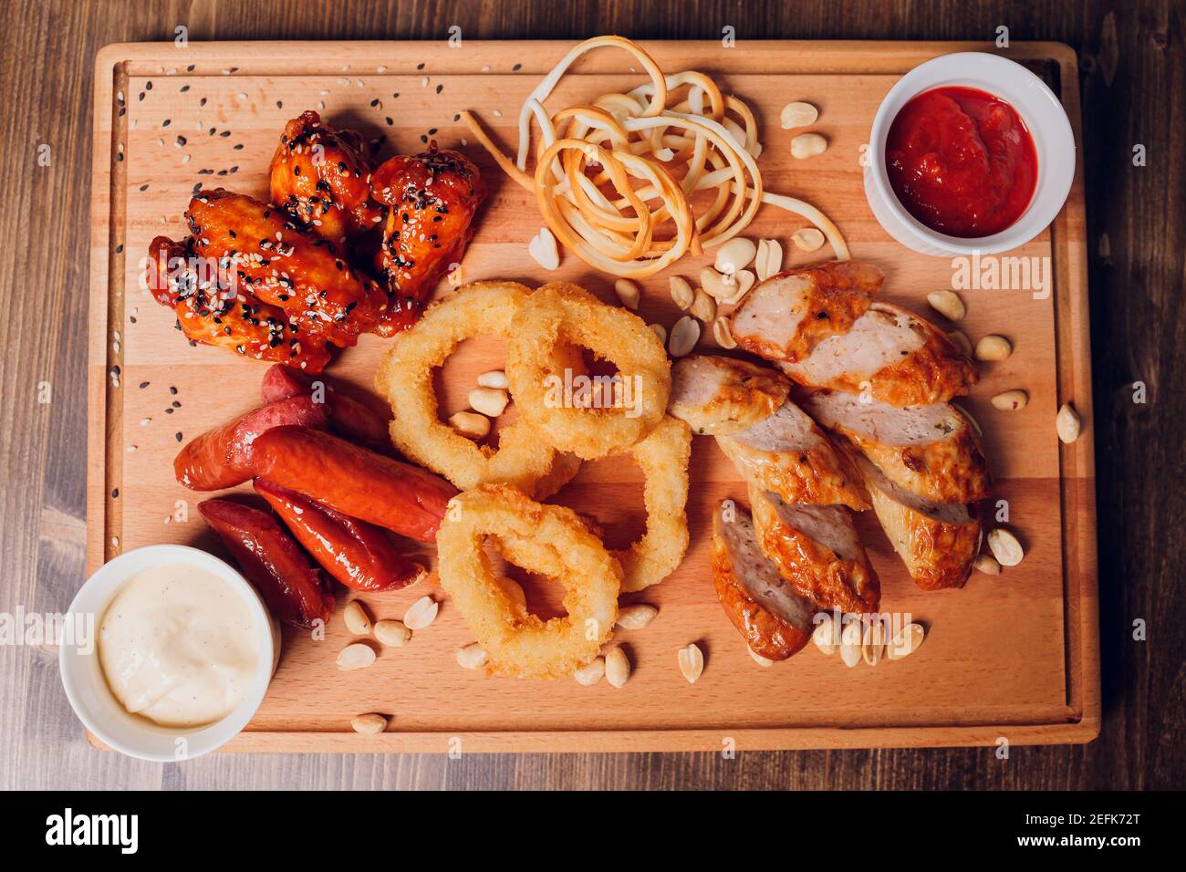 wide selection of snacks for beer with different sauces on parchment ...