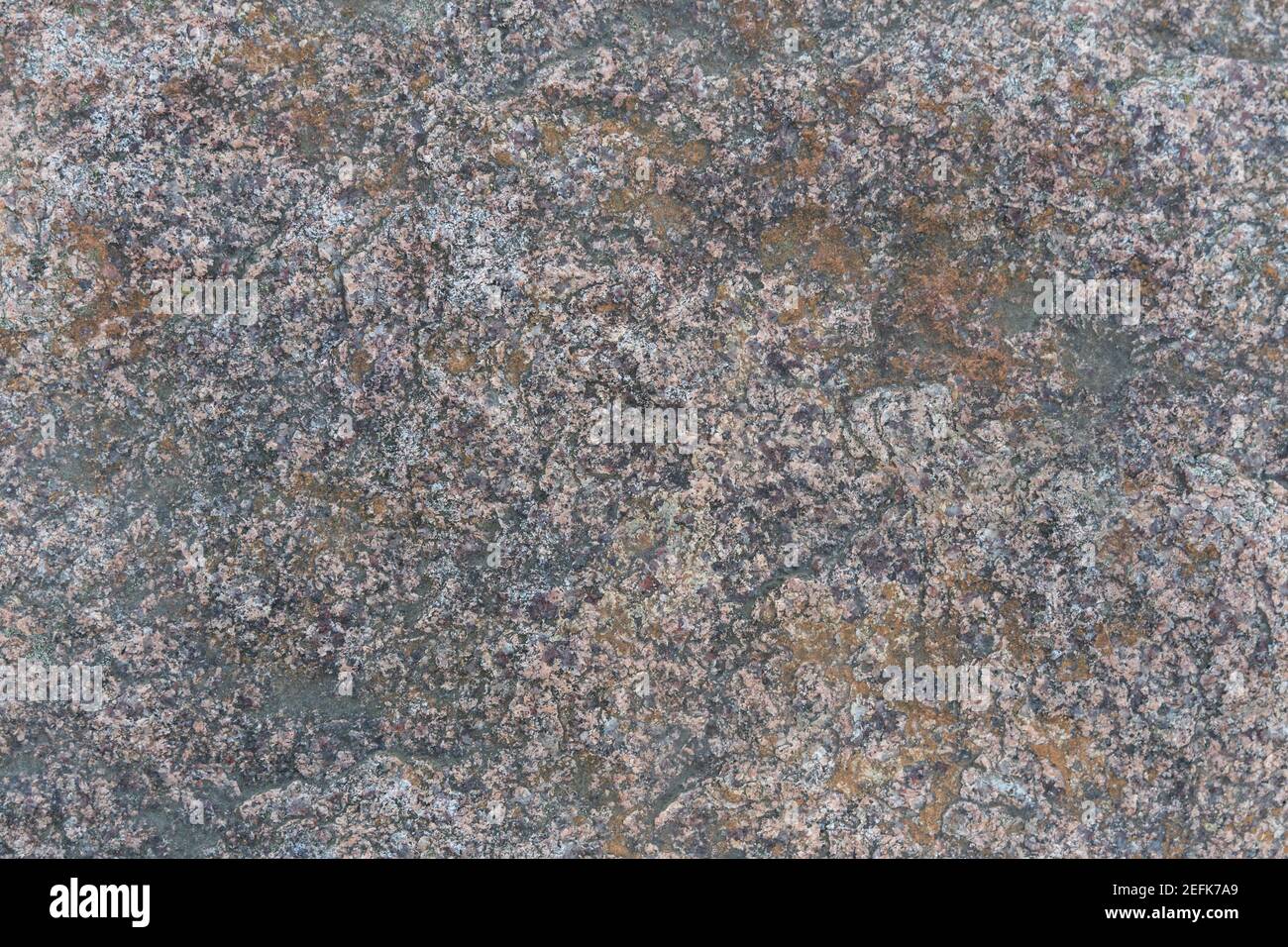 Texture pattern of a red granite stone rock with weathered aged grunge ...
