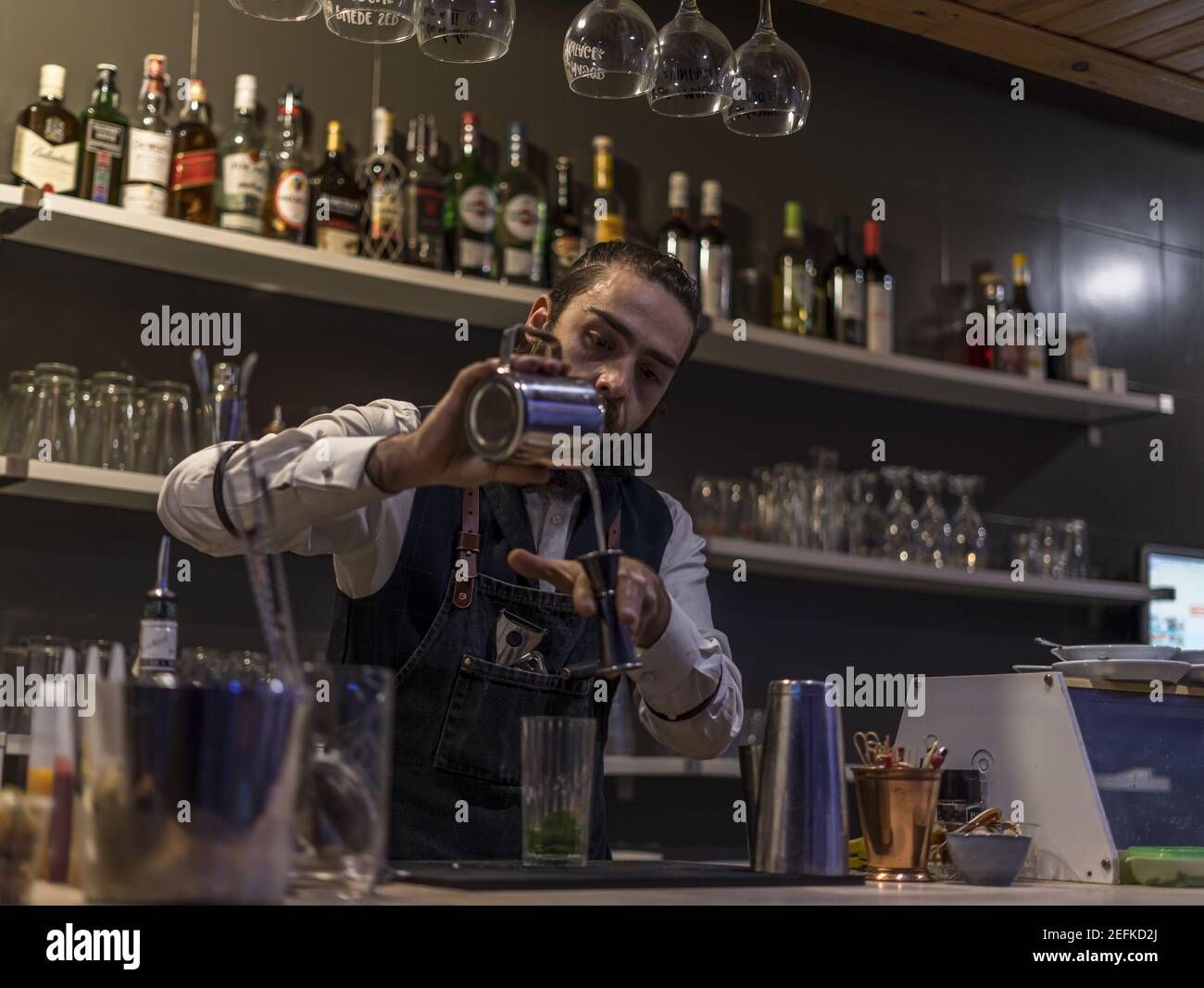 Bartender making an alcoholic drink at the night club Stock Photo - Alamy