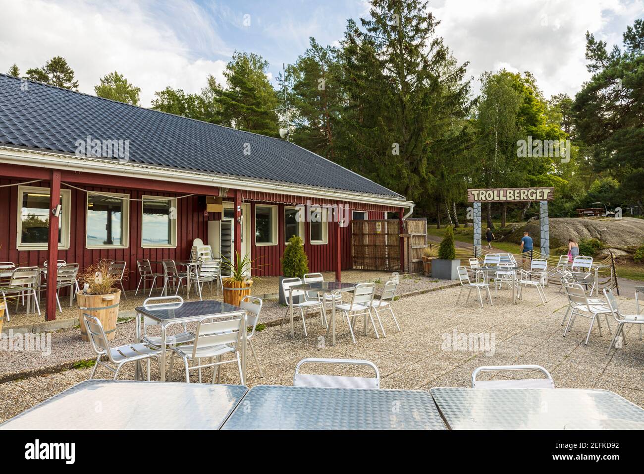 Beautiful view of outdoor eating place near red wooden building on ...