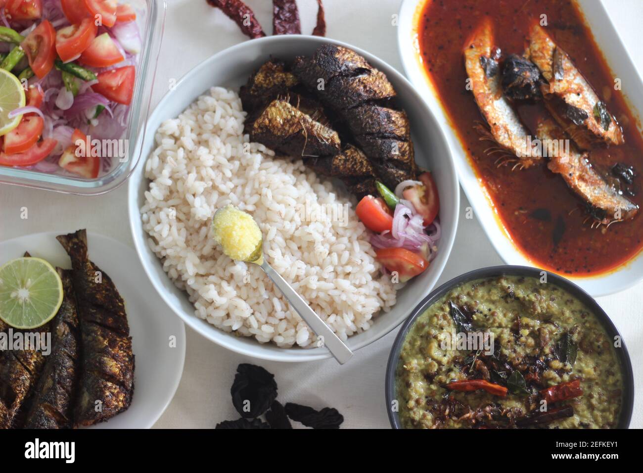 Kerala meals with red rice, sardines curry, sardine fry and coconut ...