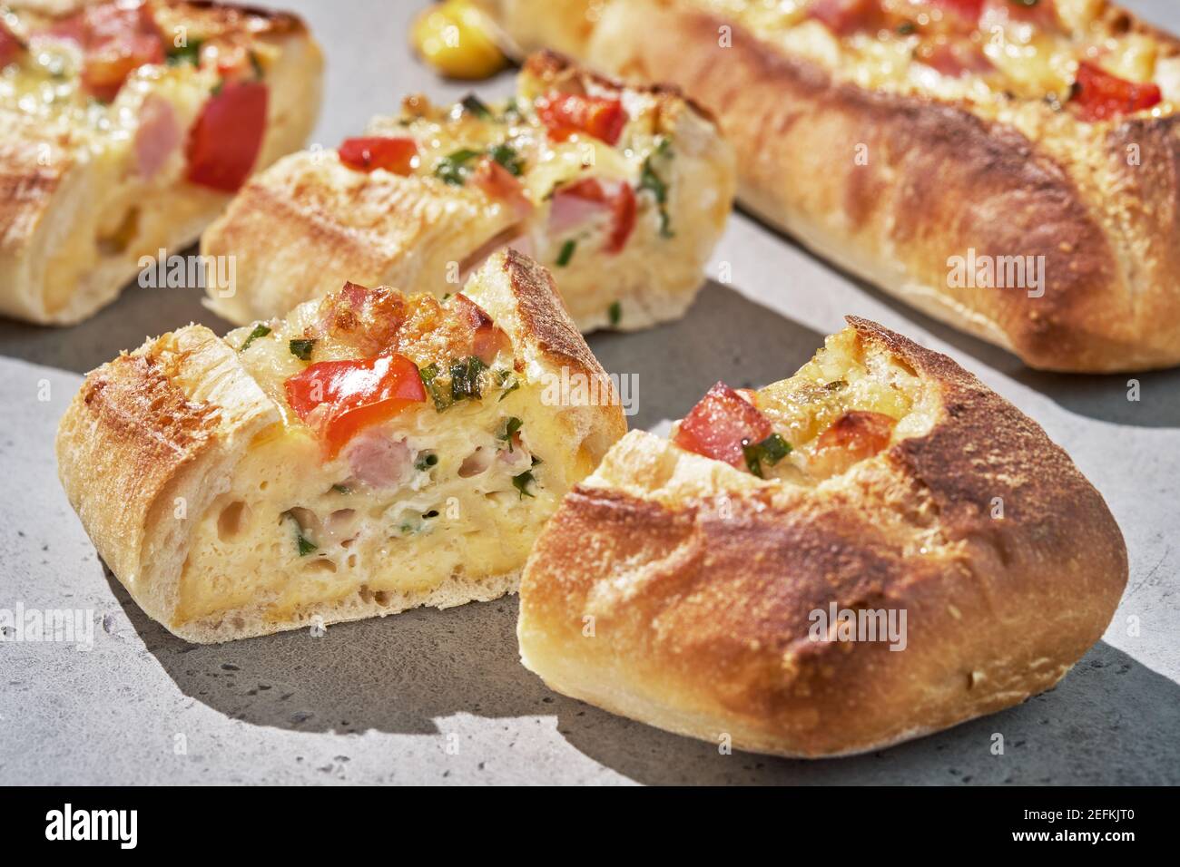 Bread boats stuffed with ham, egg, green onion and cheese for breakfast ...