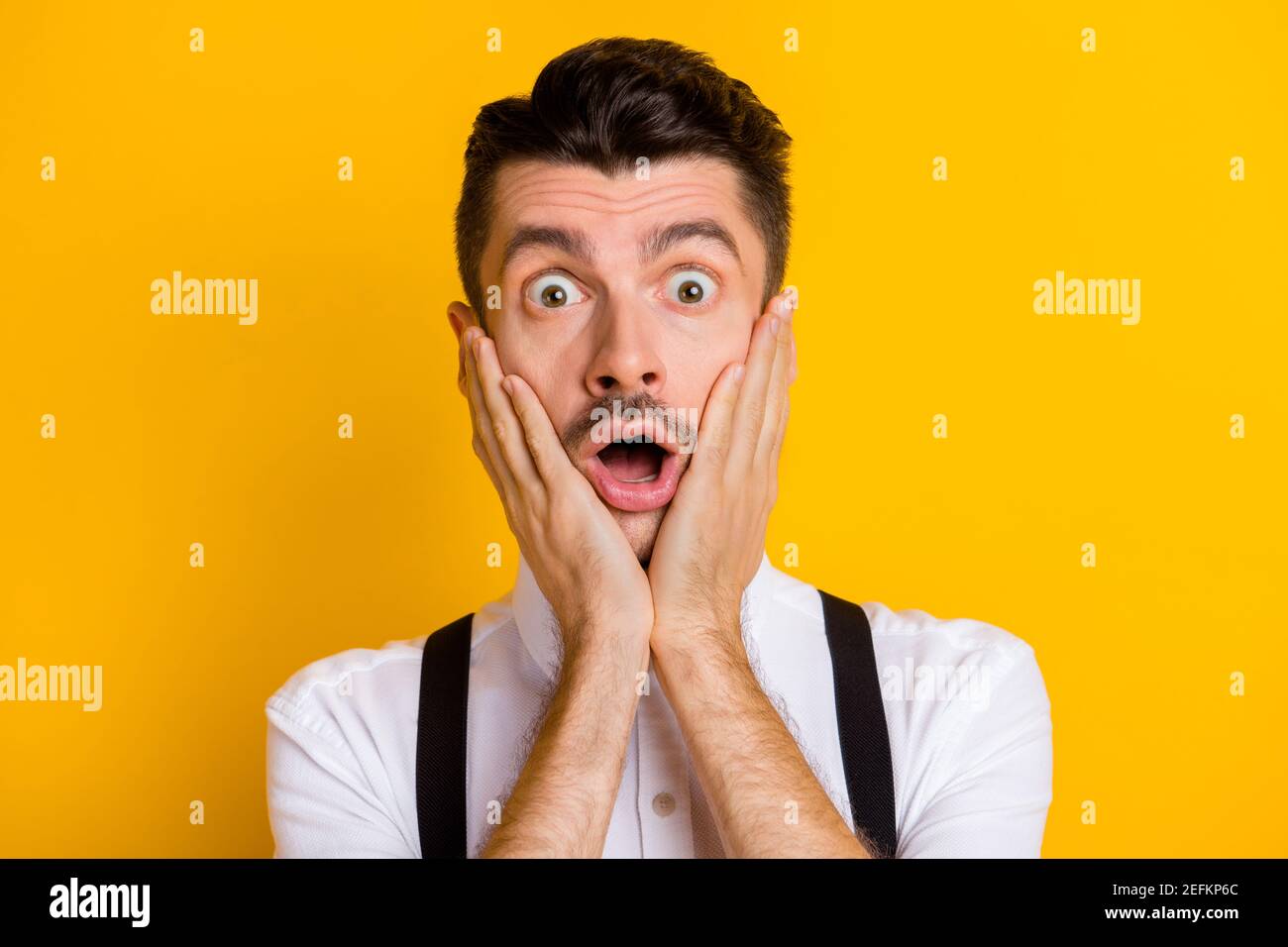 Portrait of funny attractive worried guy wearing white shirt unexpected ...