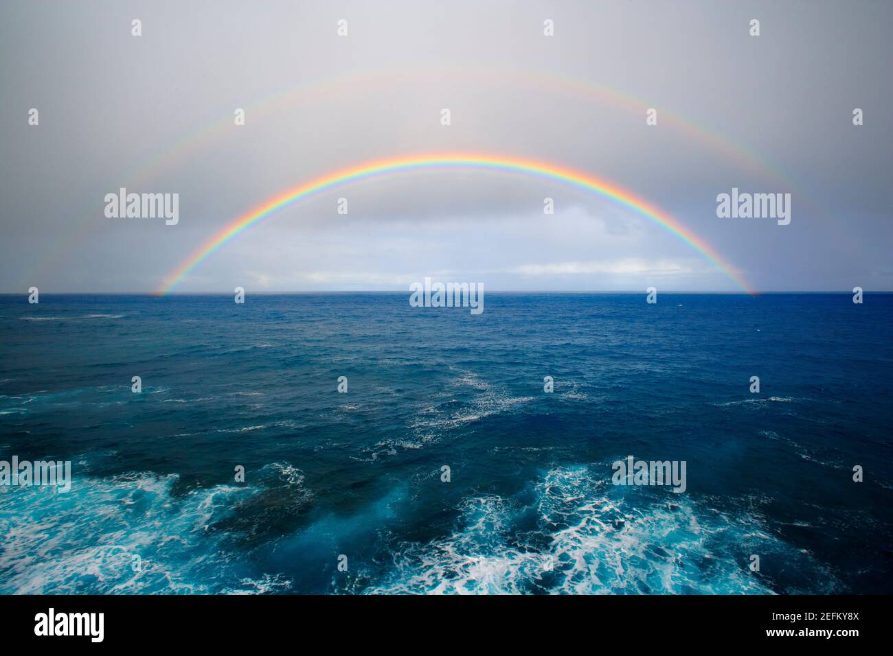 Double rainbow appears over the Pacific Ocean in the dusk at Big Island ...